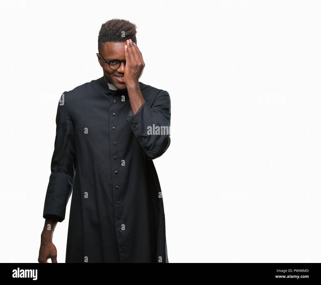 Young african american priest man over isolated background covering one ...