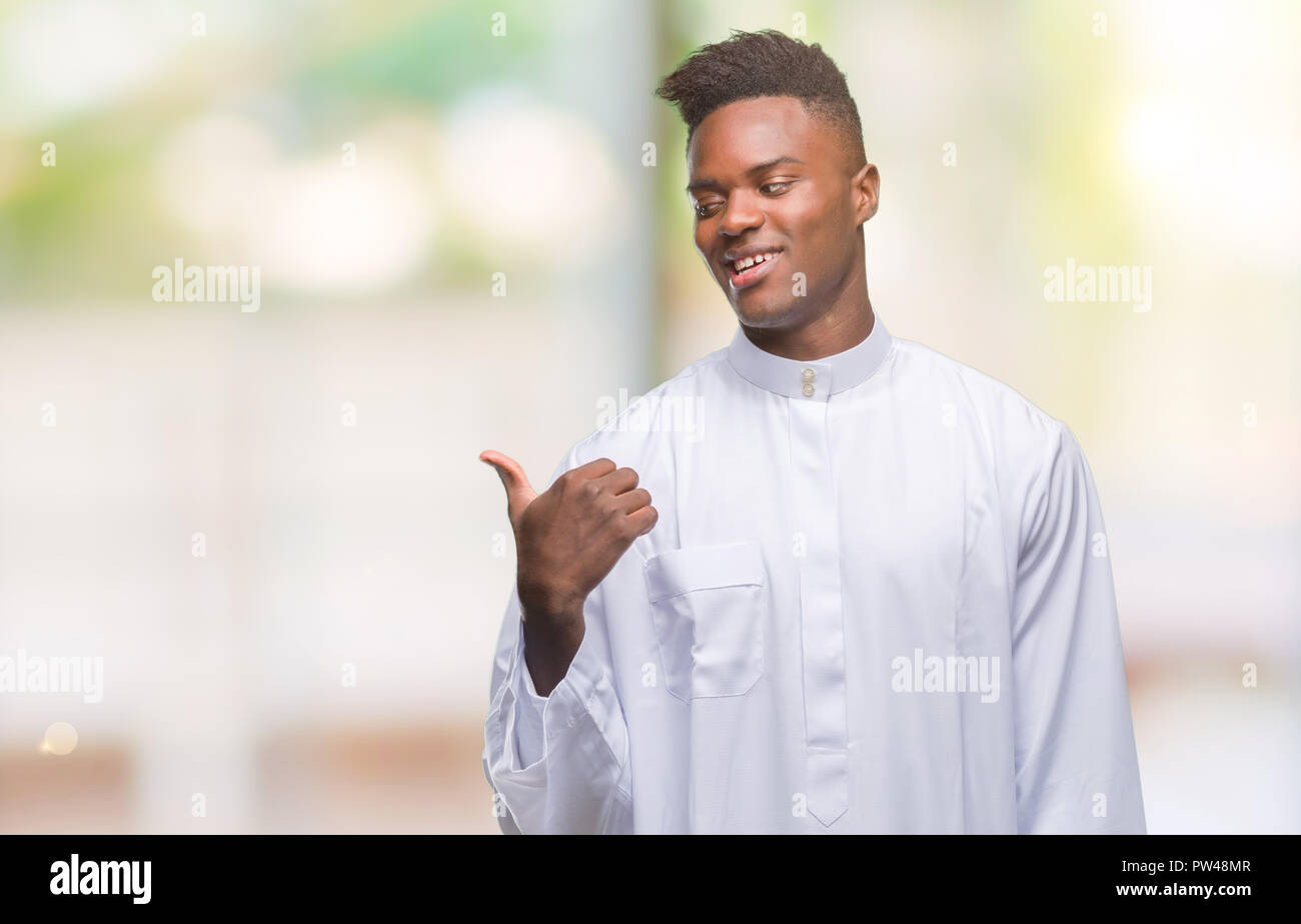 Young arabic african man wearing traditional djellaba over isolated ...