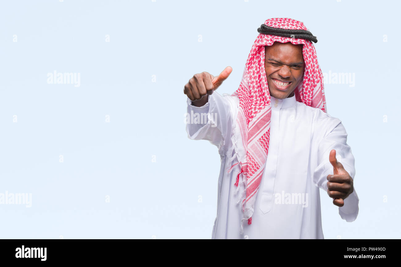 Young arabic african man wearing traditional keffiyeh over isolated ...