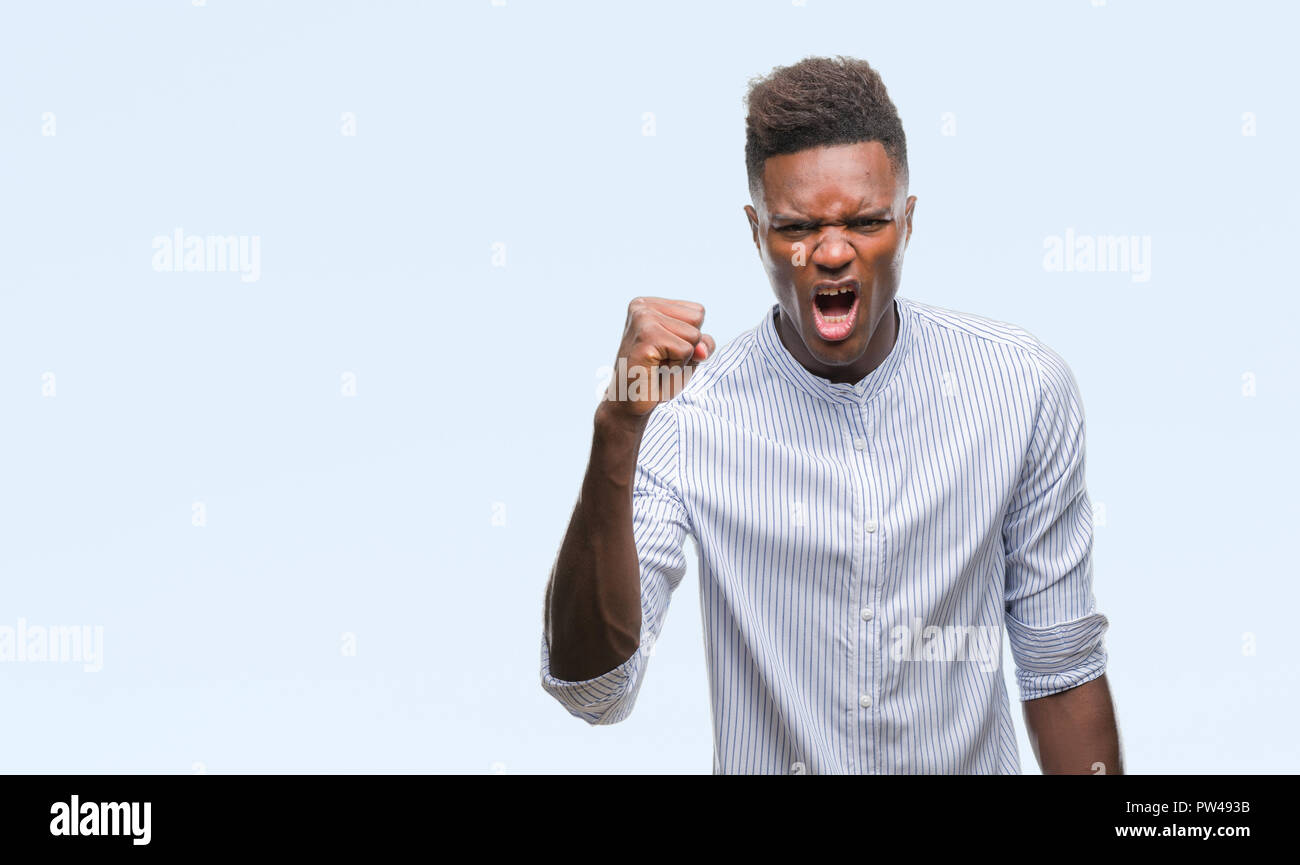 Young african american man over isolated background angry and mad ...