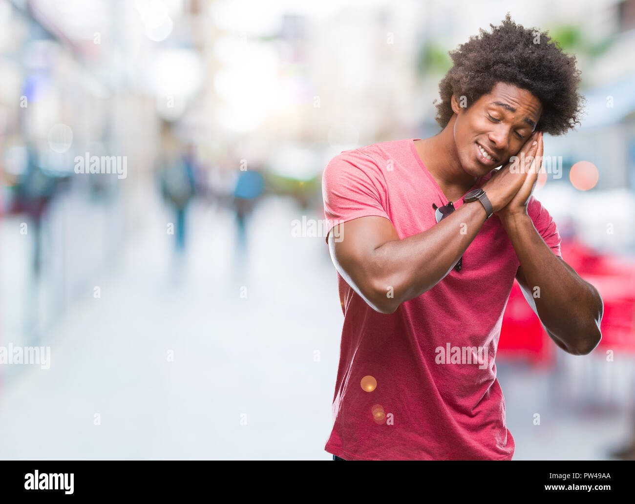 Afro american man over isolated background sleeping tired dreaming and ...
