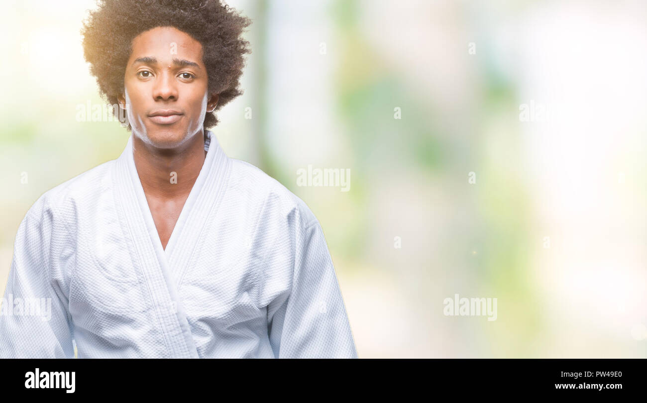 Afro american man wearing karate kimono over isolated background with ...