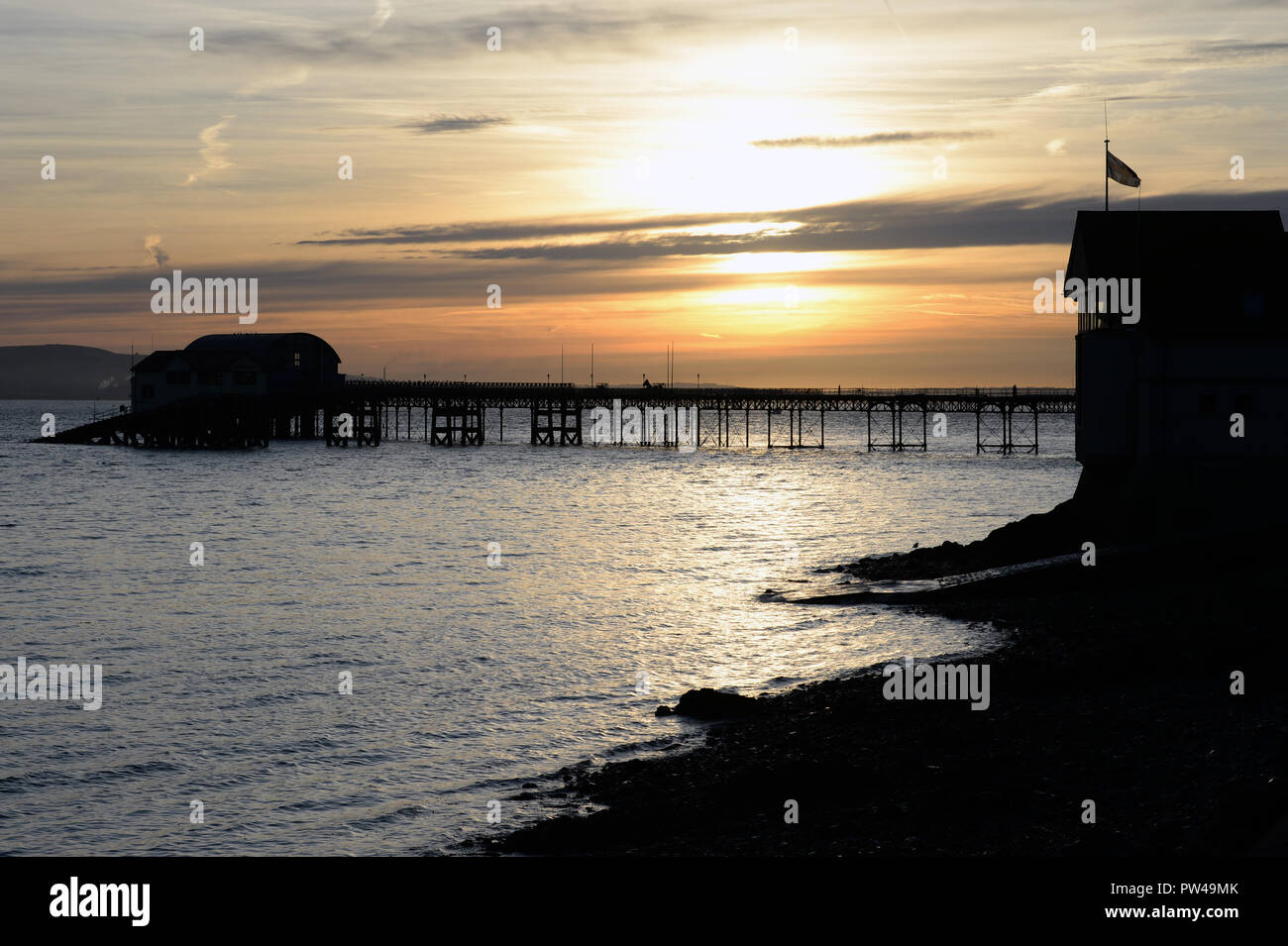 sunrise over mumbles pier and lifeboat station Stock Photo - Alamy