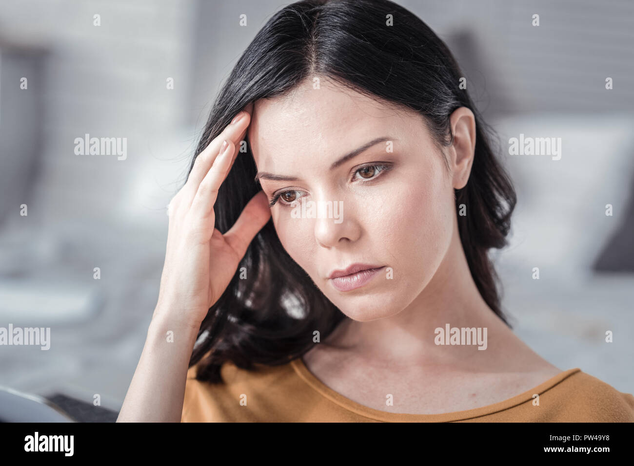 Serious woman touching her forehead Stock Photo - Alamy Serious woman touching her forehead Stock Photo - Alamy
