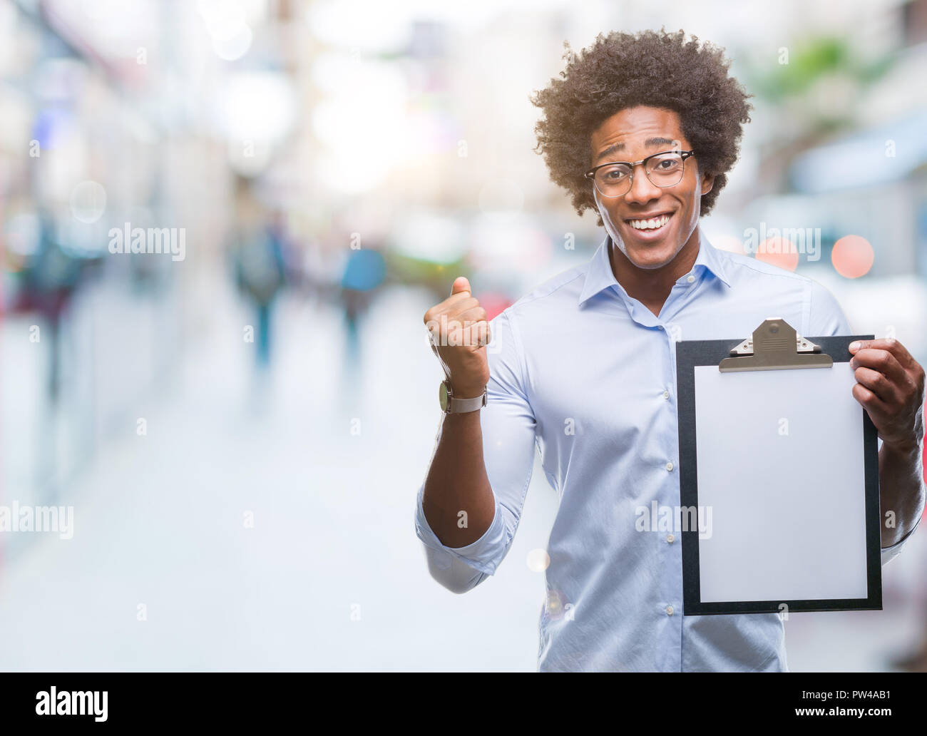 Afro american man holding clipboard over isolated background screaming ...