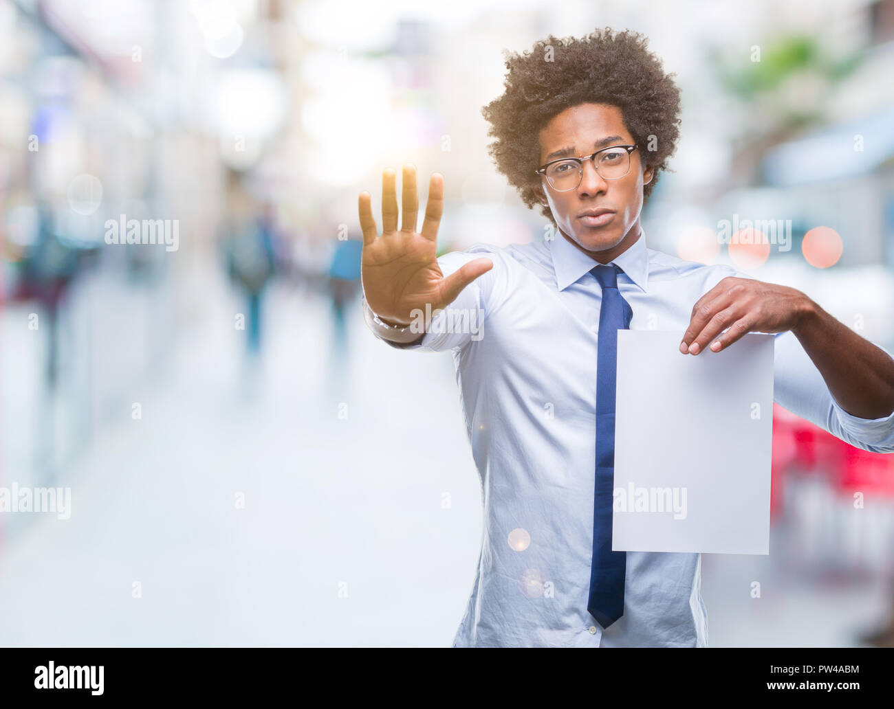 Afro american man holding blank paper contract over isolated background ...