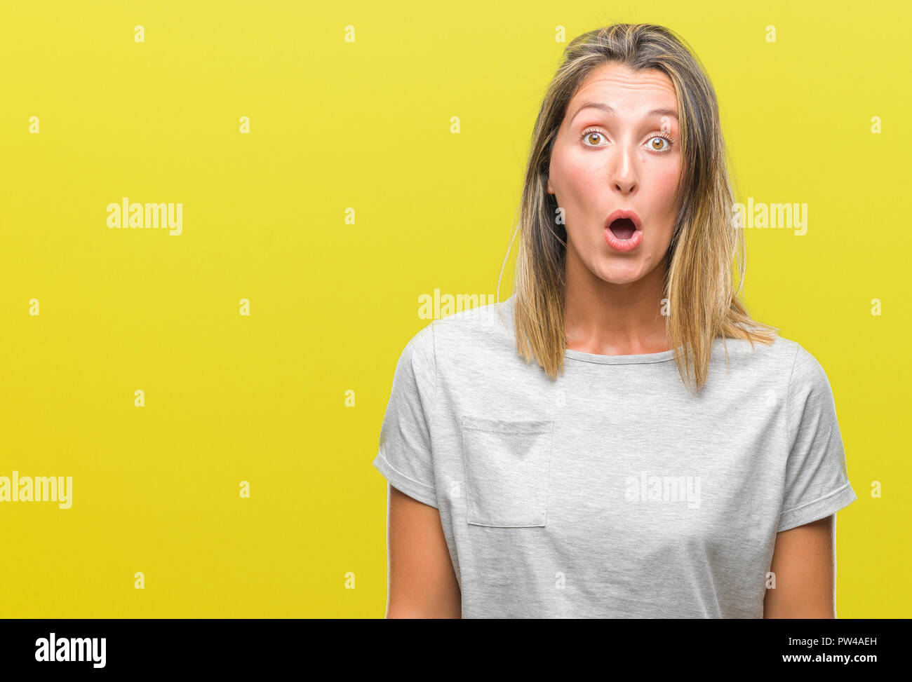 Young beautiful woman over isolated background afraid and shocked with ...