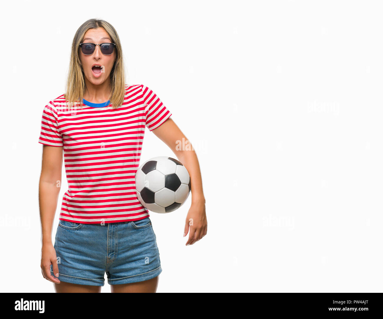 Young beautiful woman holding soccer football ball over isolated ...