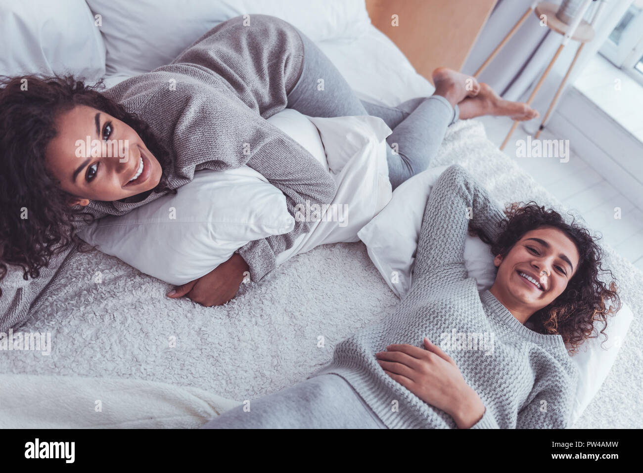 Beautiful friends watching movie together Stock Photo - Alamy
