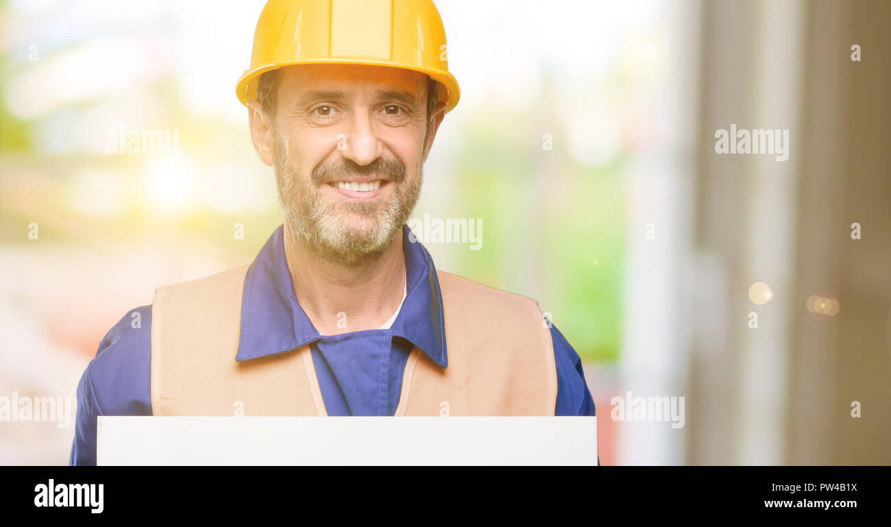 Senior engineer man, construction worker holding blank advertising ...