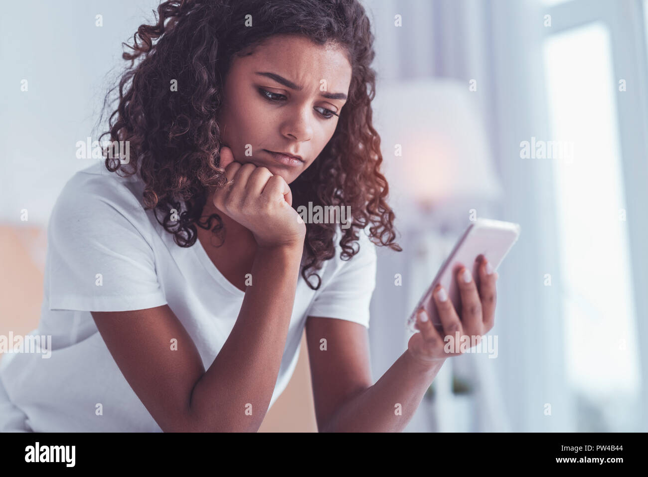 Young woman feeling sad while watching drama movie Stock Photo - Alamy