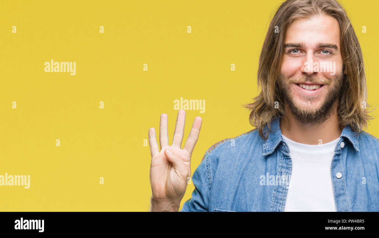 Young handsome man with long hair over isolated background showing and ...