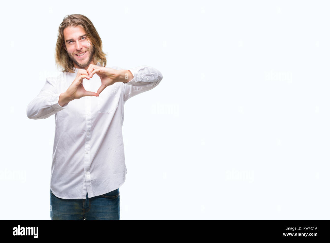 Young handsome man with long hair over isolated background smiling in ...
