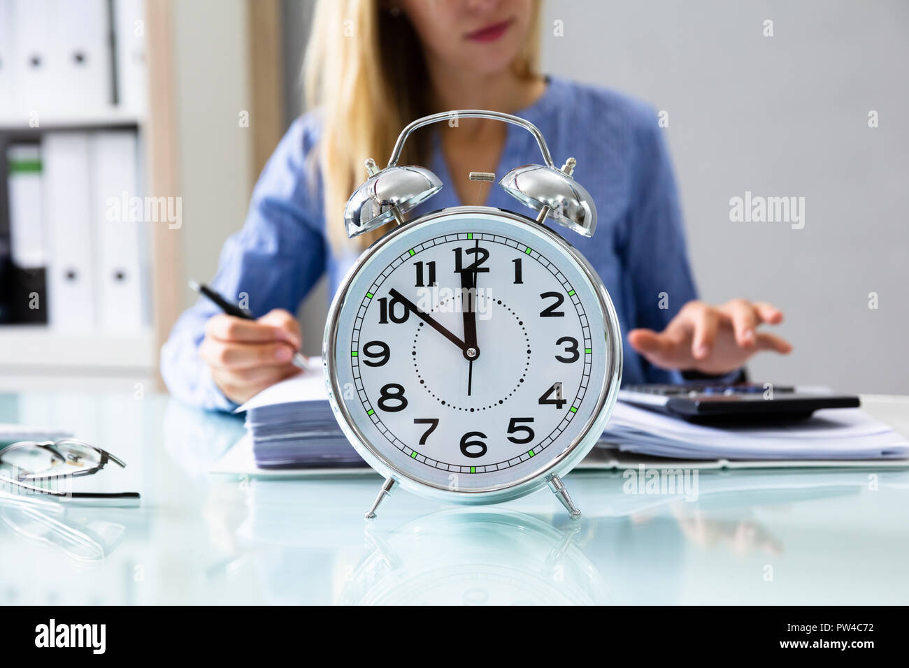 Woman checking clock office hi-res stock photography and images - Alamy