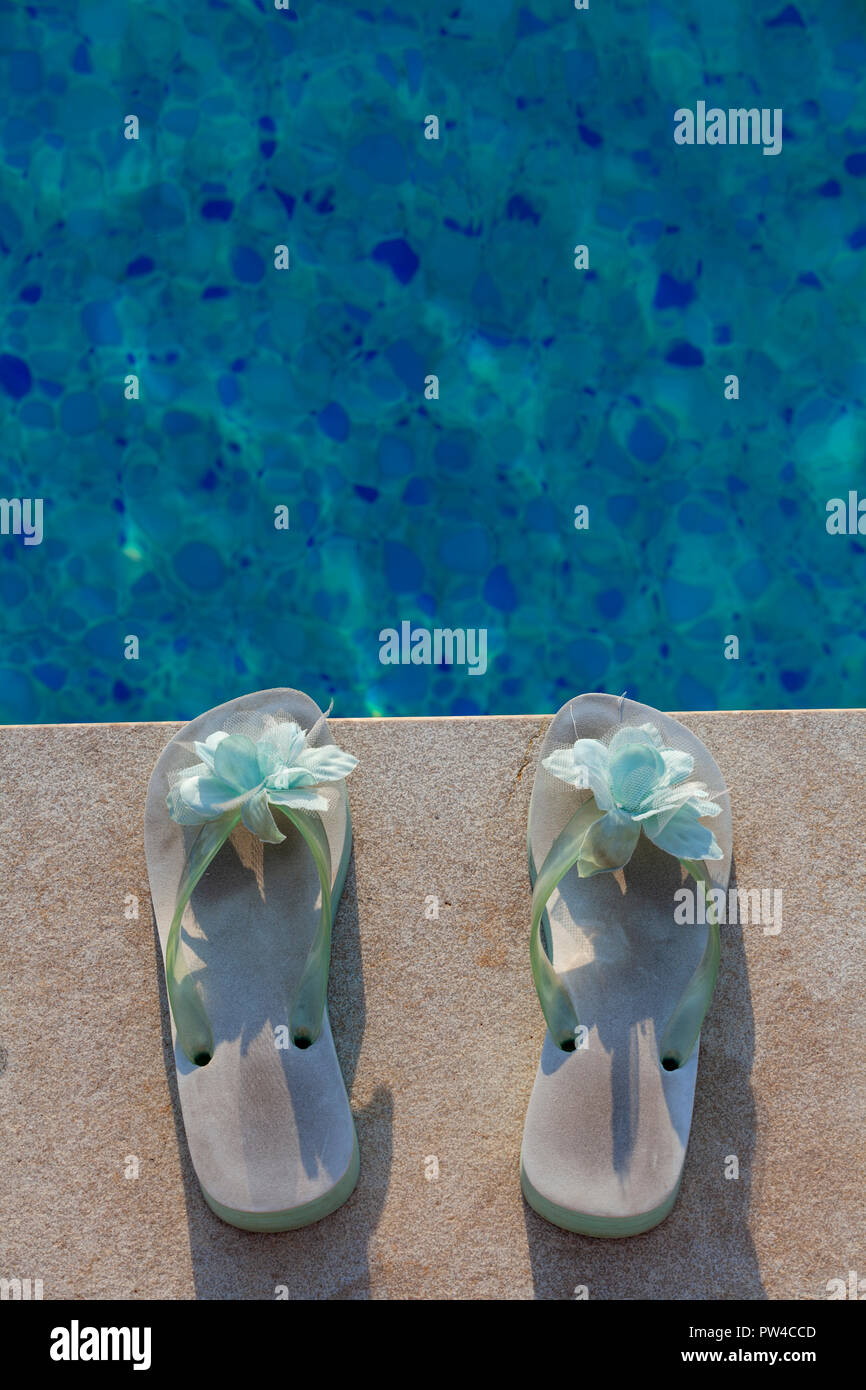 Flip flop sandals by swimming pool Stock Photo - Alamy