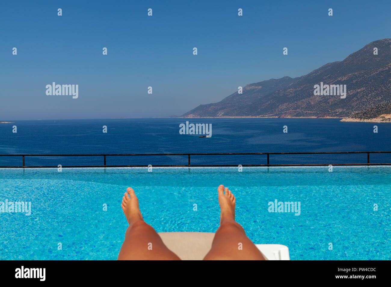 Sunbathing with a view of a pool and the sea Stock Photo - Alamy