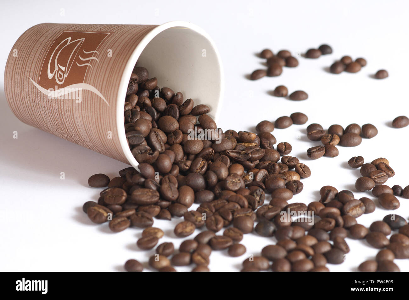 Dropped coffee beans. Coffee beans dropped into the paper. Glass with ...
