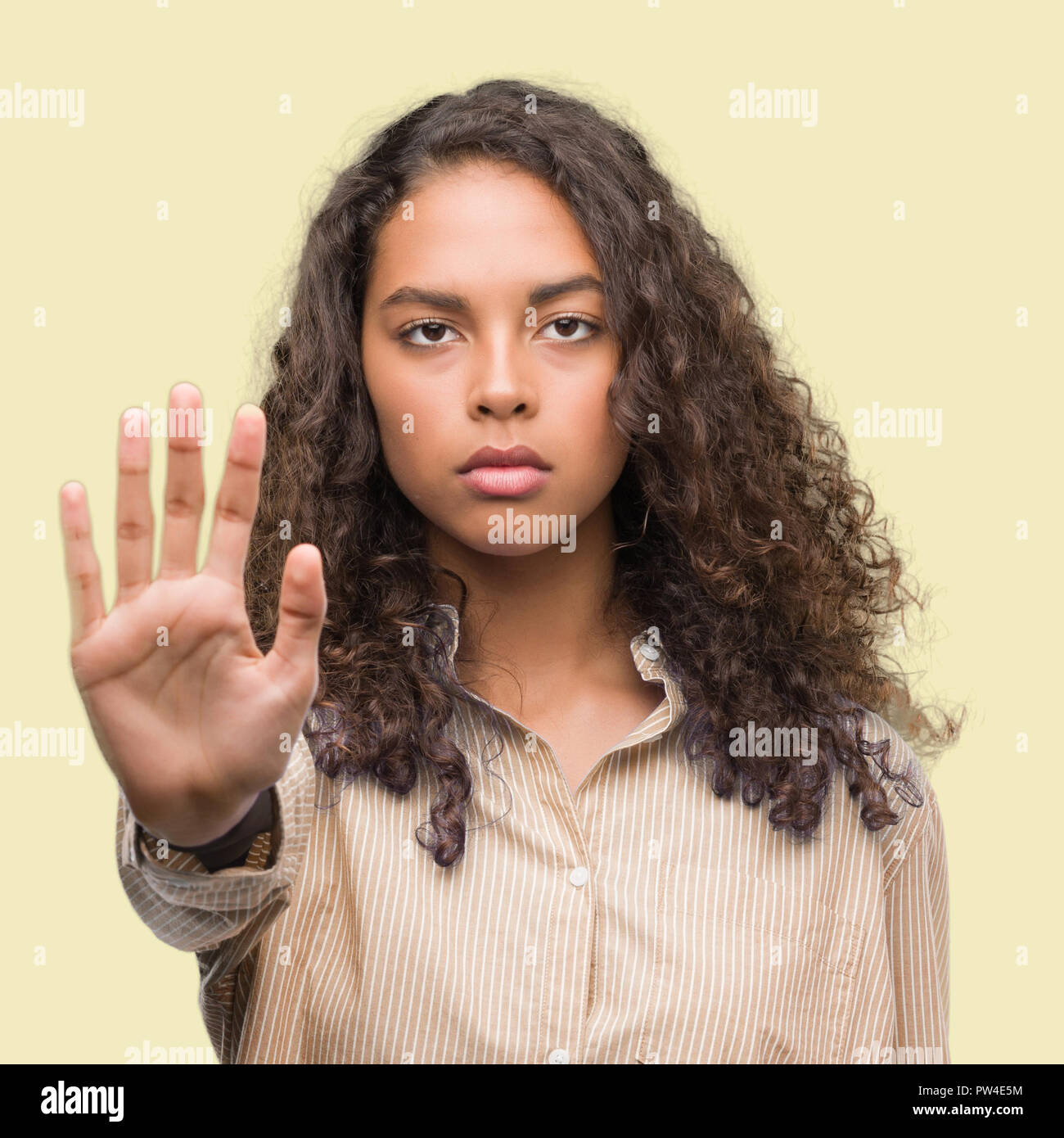 Young hispanic business woman doing stop sing with palm of the hand ...