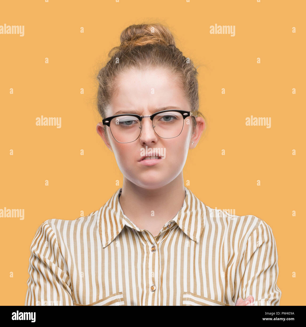 Young blonde business woman skeptic and nervous, disapproving ...