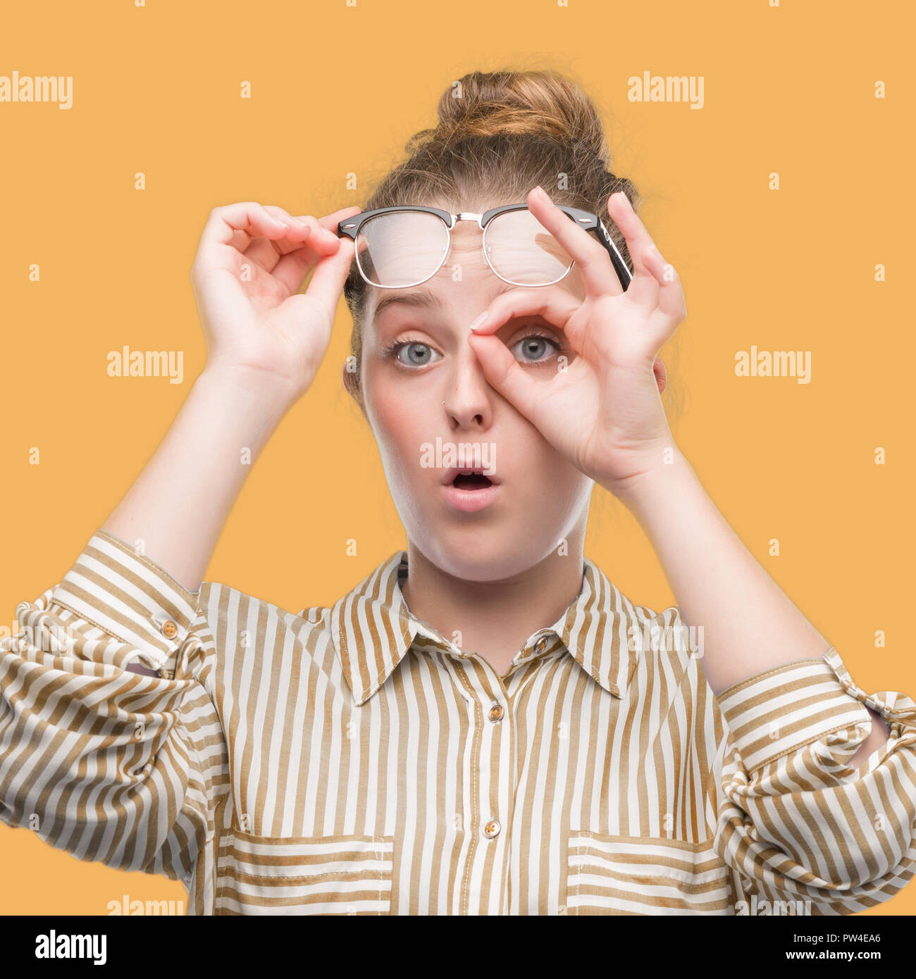 Young blonde business woman doing ok gesture shocked with surprised ...