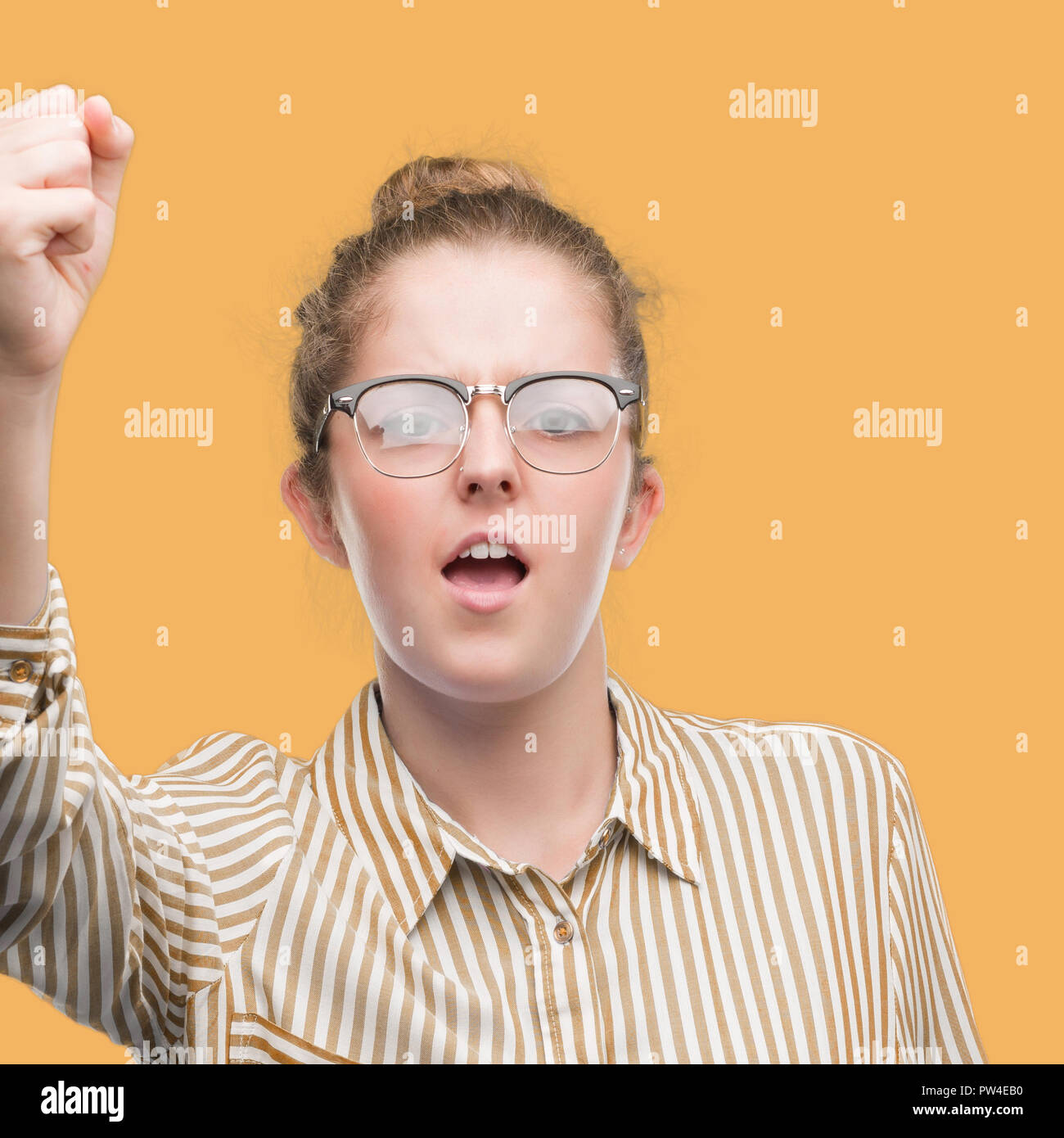 Angry young woman raising hand hi-res stock photography and images - Alamy