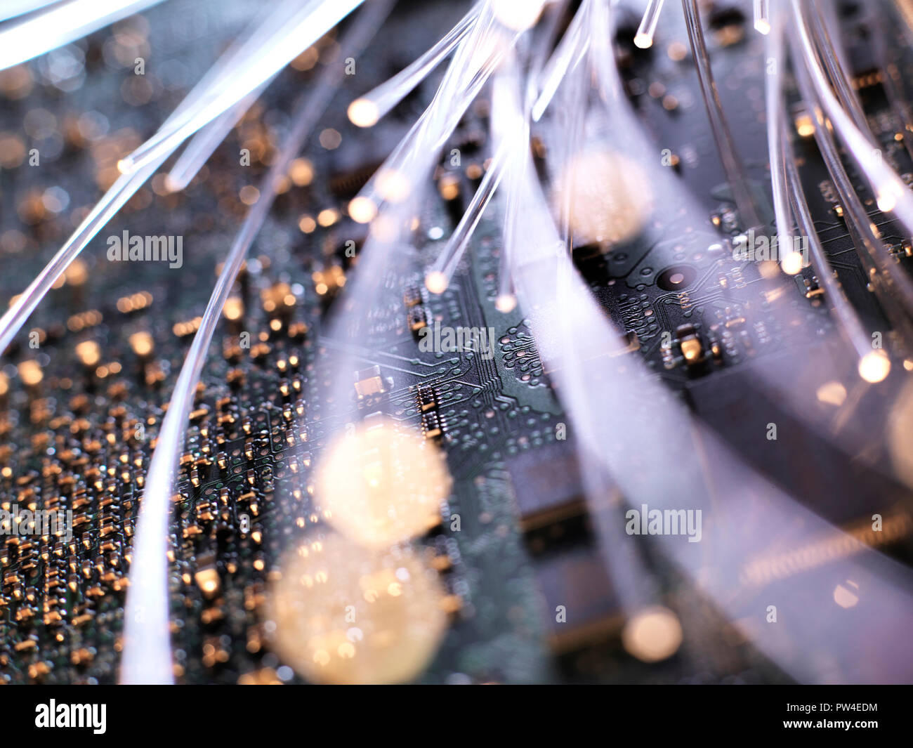 Close-up of illuminated fiber optics on circuit board of laptop ...