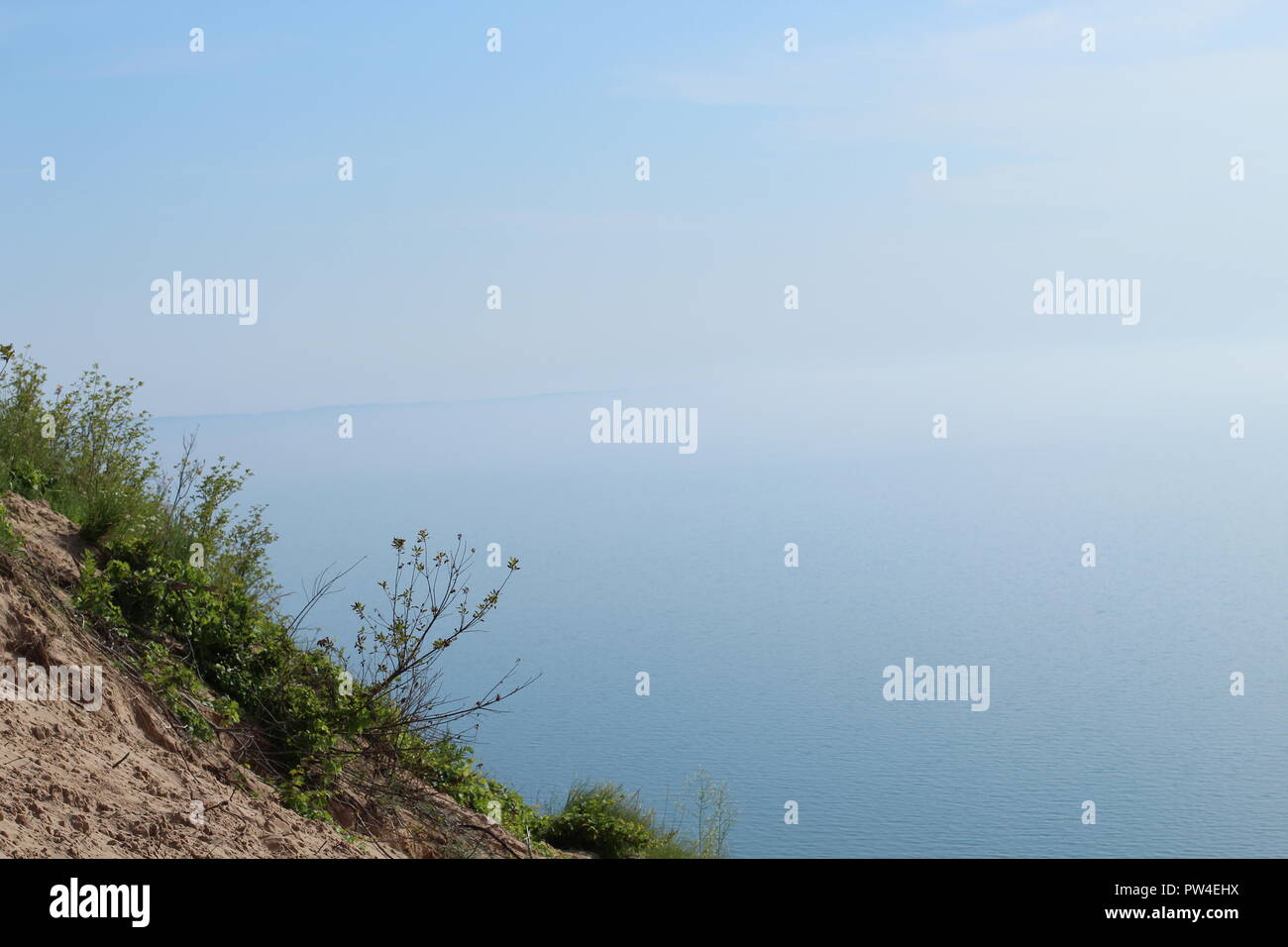 A sand dune with the blue waters of Lake Michigan in Sleeping Bear ...
