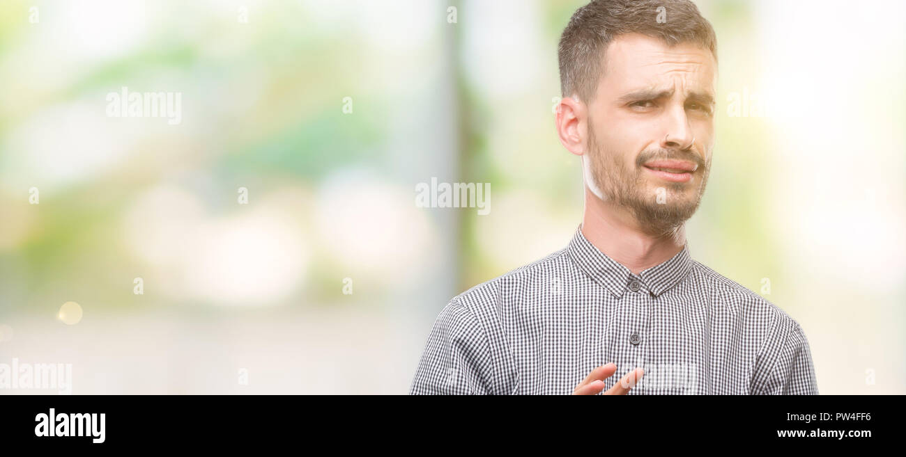 Young hipster man disgusted expression, displeased and fearful doing ...