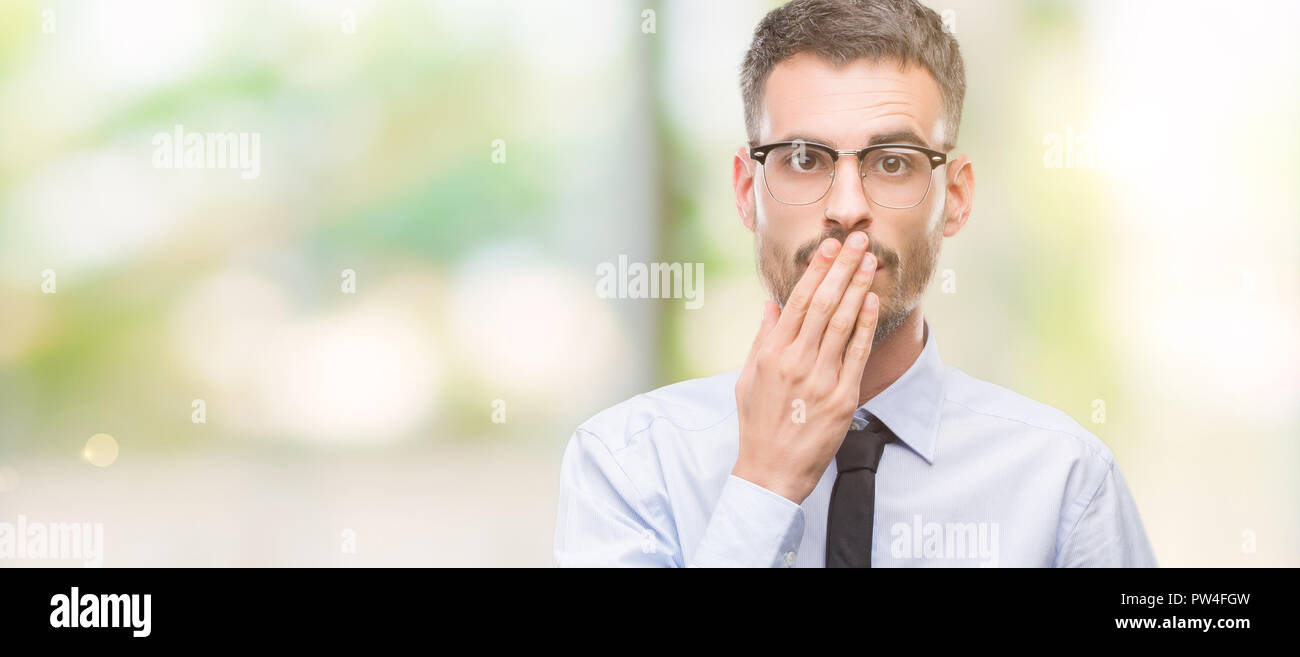 Young business man cover mouth with hand shocked with shame for mistake ...
