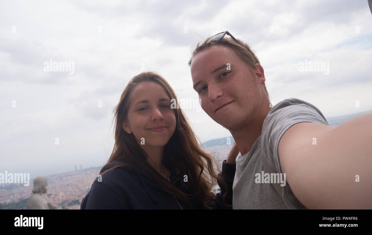 A young couple taking a selfie on observation deck. Barcelona city ...