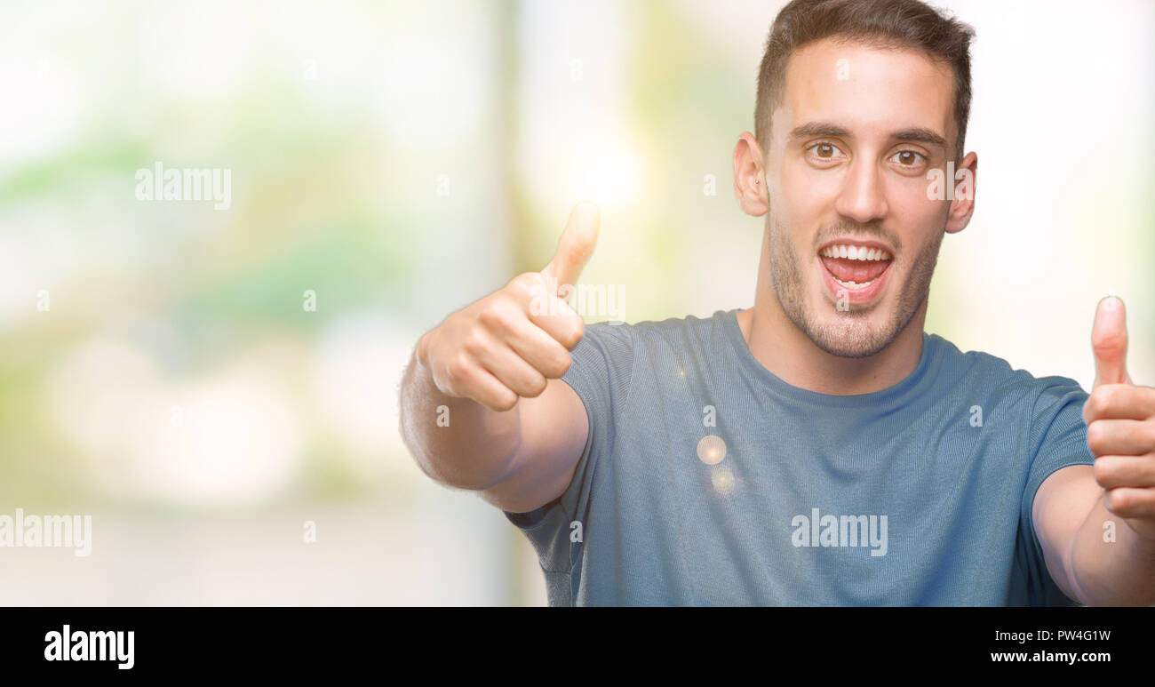 Handsome young casual man approving doing positive gesture with hand ...