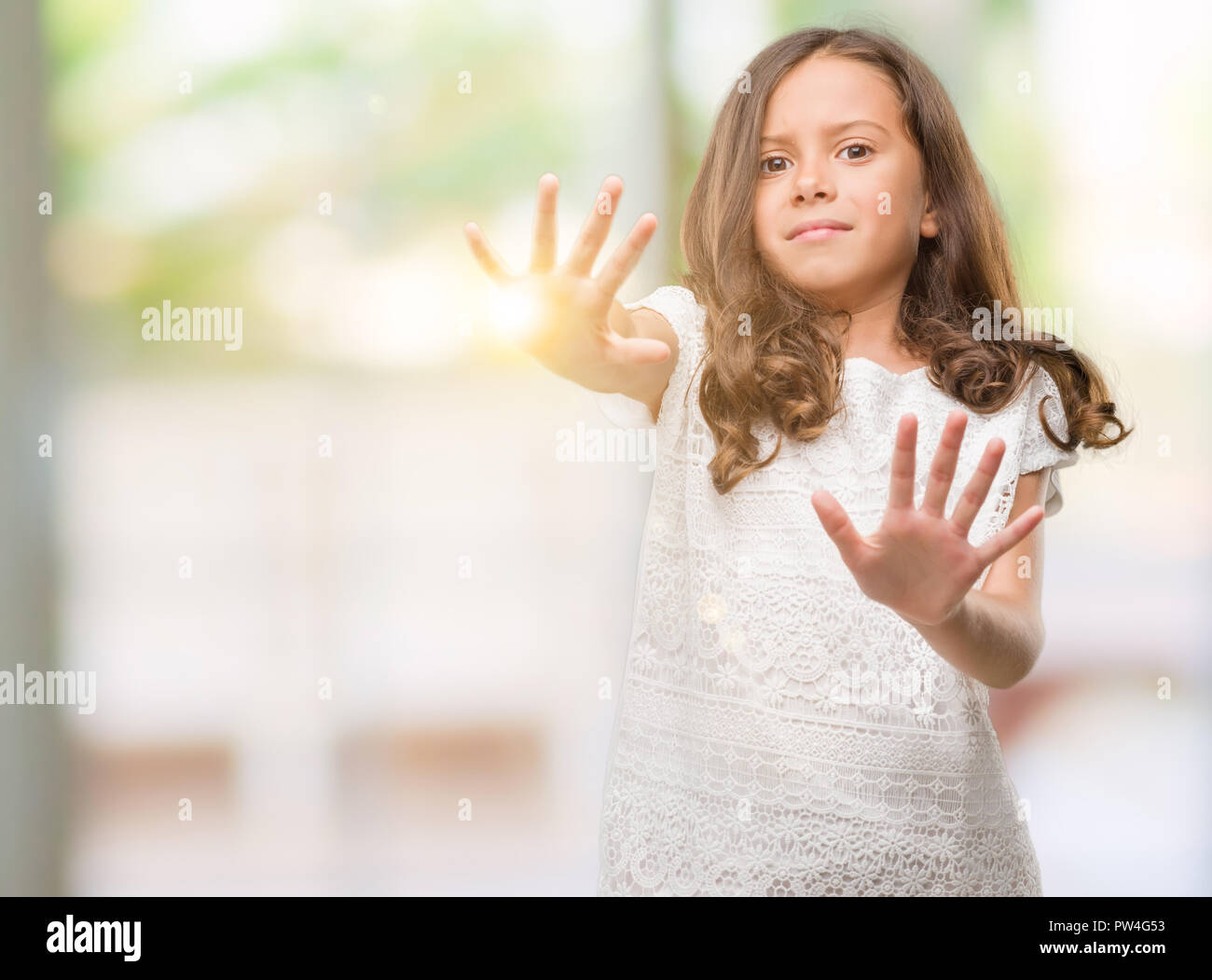 Brunette hispanic girl afraid and terrified with fear expression stop ...