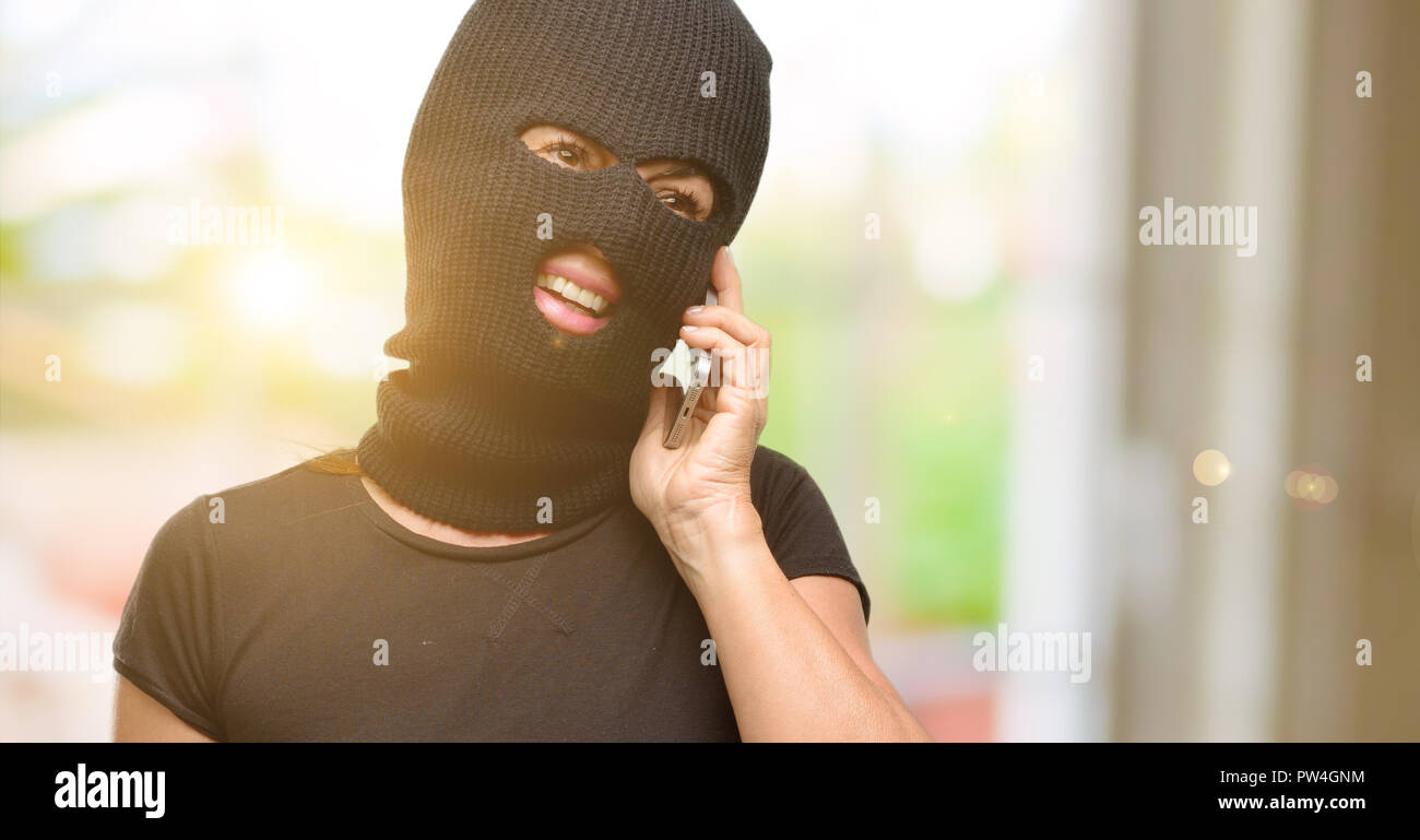 Burglar terrorist woman wearing balaclava ski mask happy talking using ...