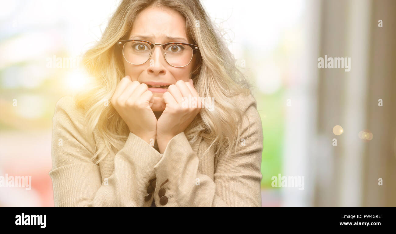 Young beautiful woman terrified and nervous expressing anxiety and ...
