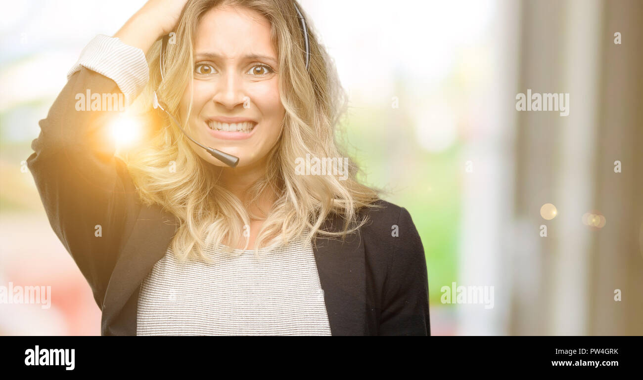 Young woman operator from call center terrified and nervous expressing ...