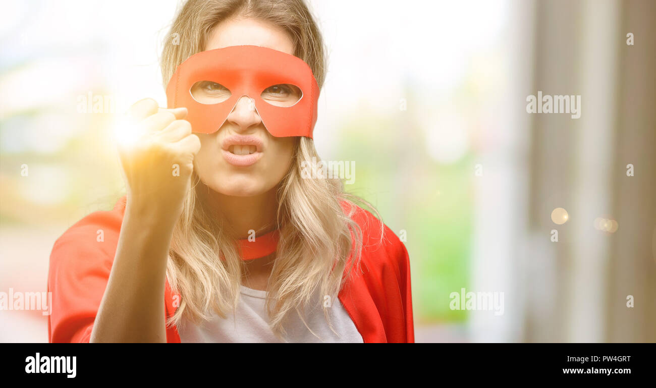 Young super hero woman wearing cape irritated and angry expressing ...