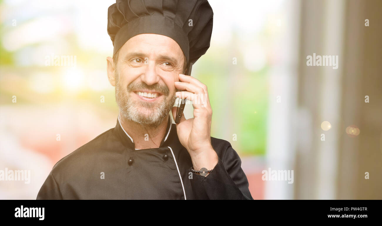 Man cooking food using smartphone hi-res stock photography and images ...
