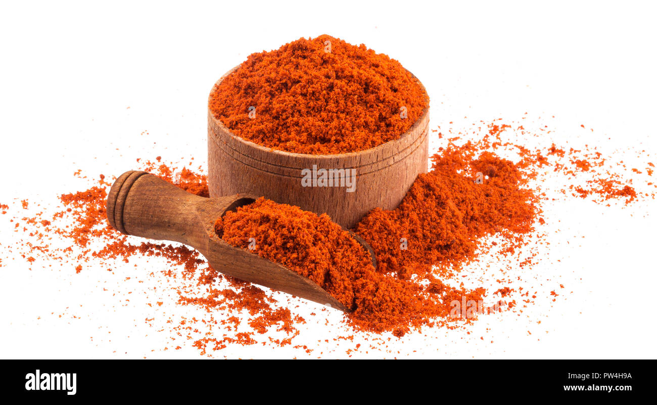 Pile of red paprika powder in wooden bowl and scoop isolated on white ...