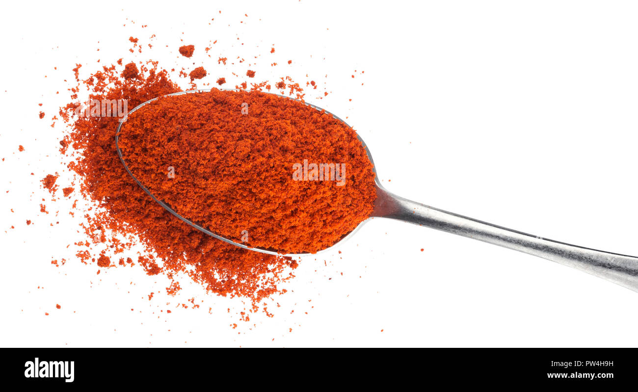 Pile of red paprika powder in spoon isolated on white background, top ...
