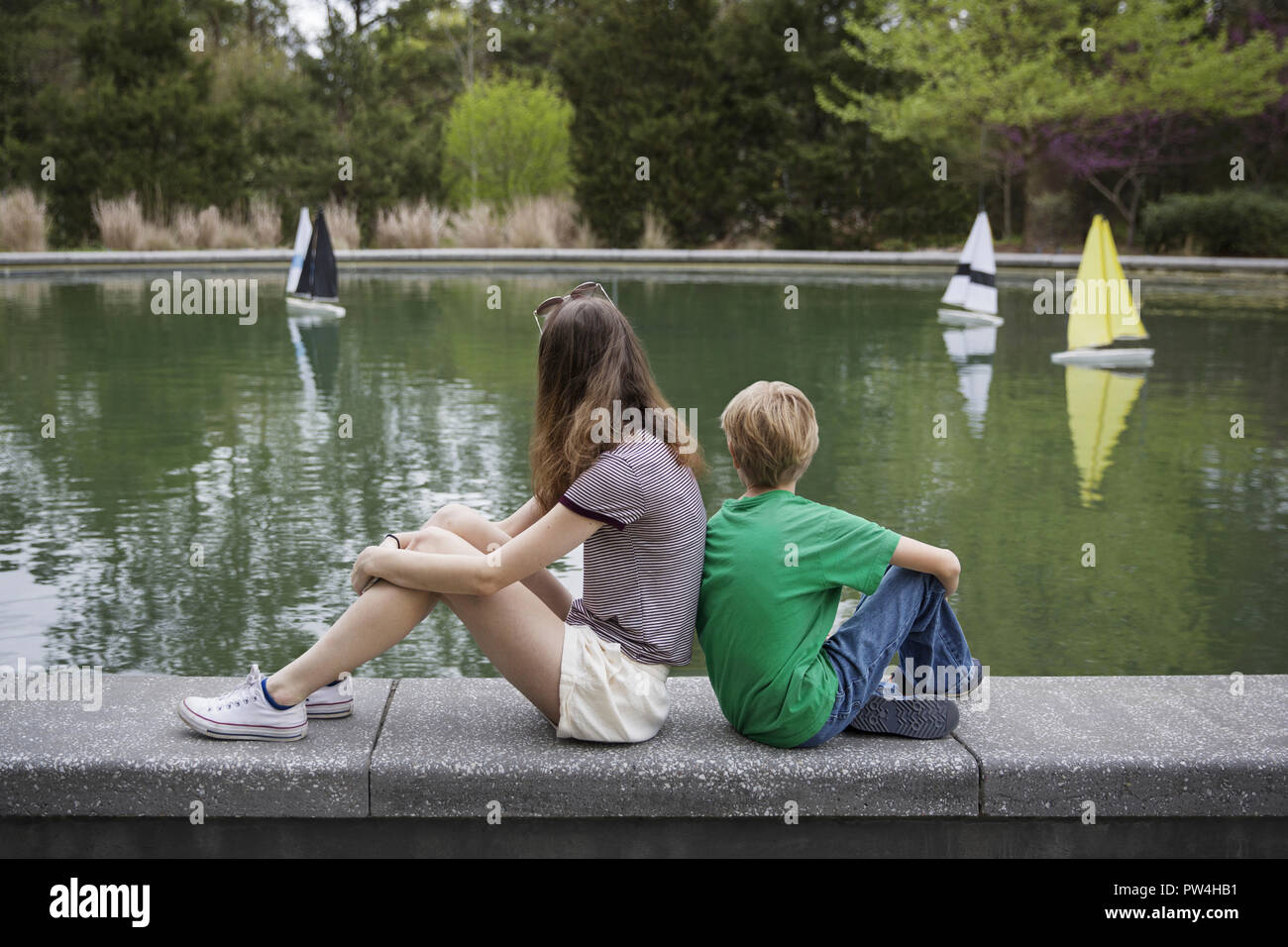 Back view brother sister sitting hi-res stock photography and images ...