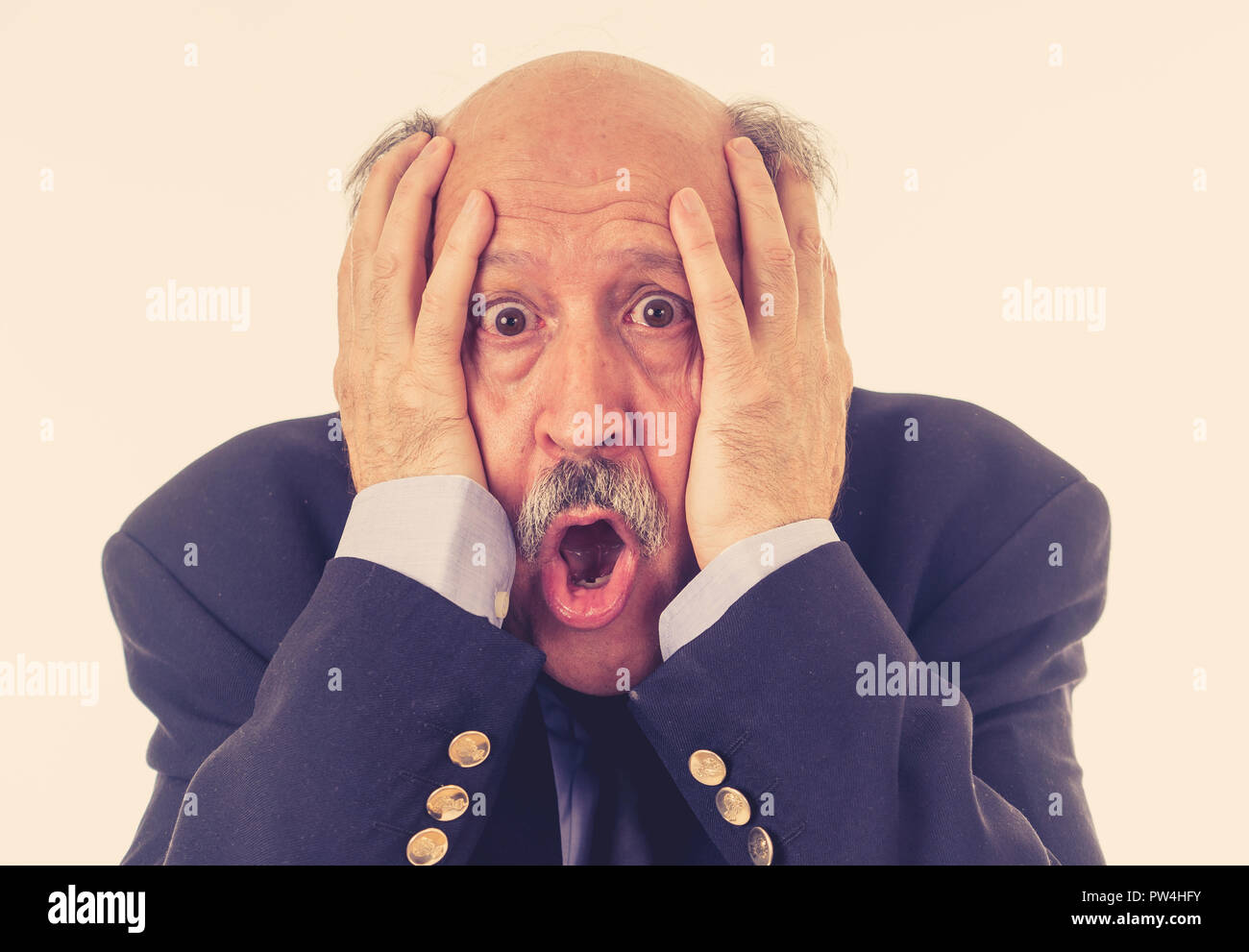 Portrait of a 60s senior man in shock with a scared expression on his ...