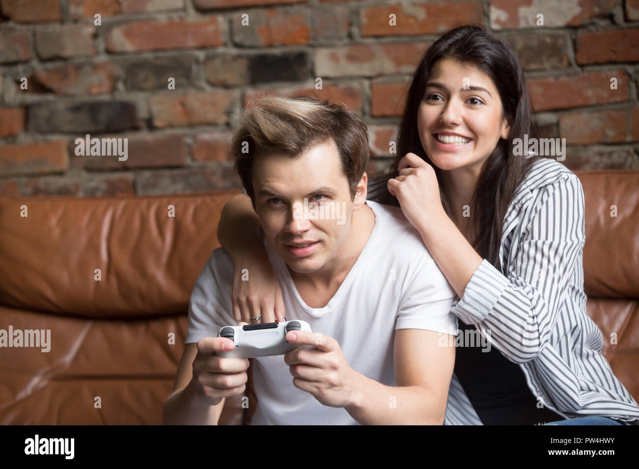 Excited couple playing video games together at home Stock Photo - Alamy
