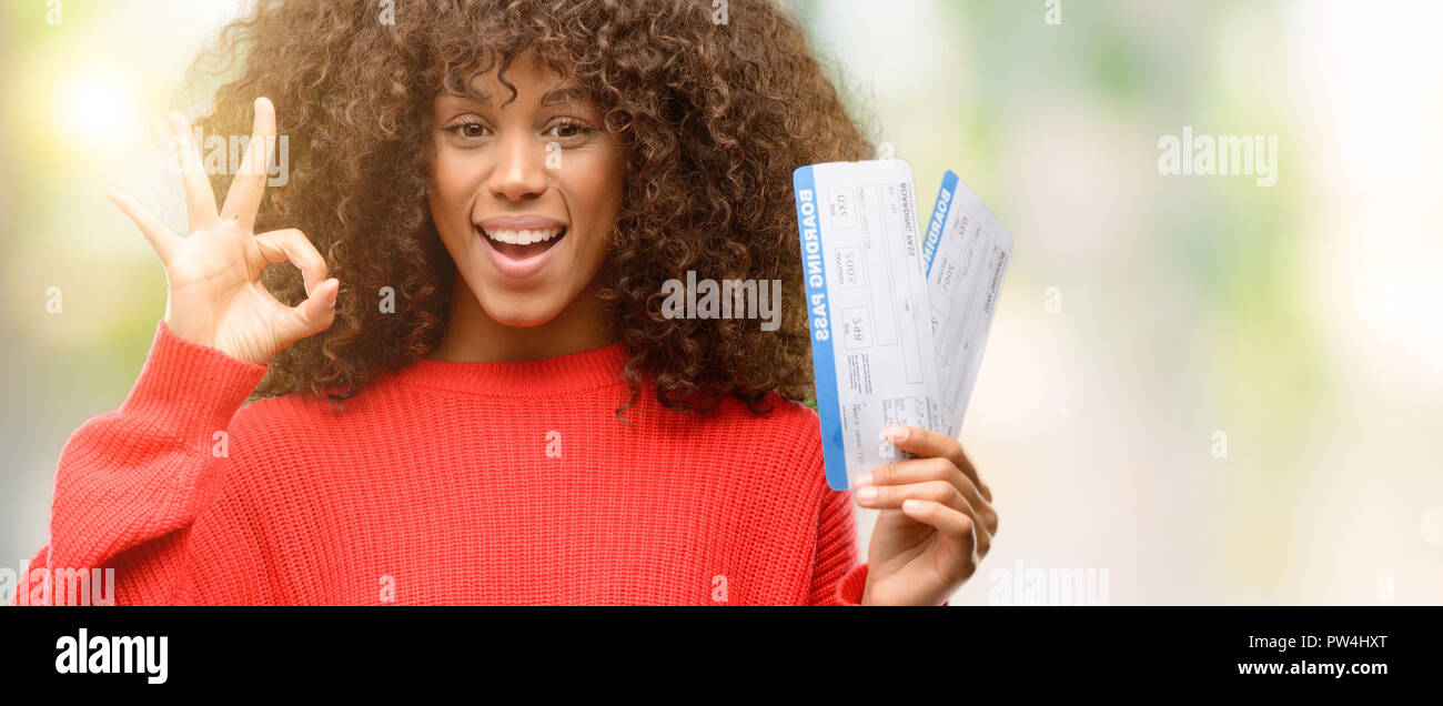 African american woman holding airline boarding pass tickets doing ok ...