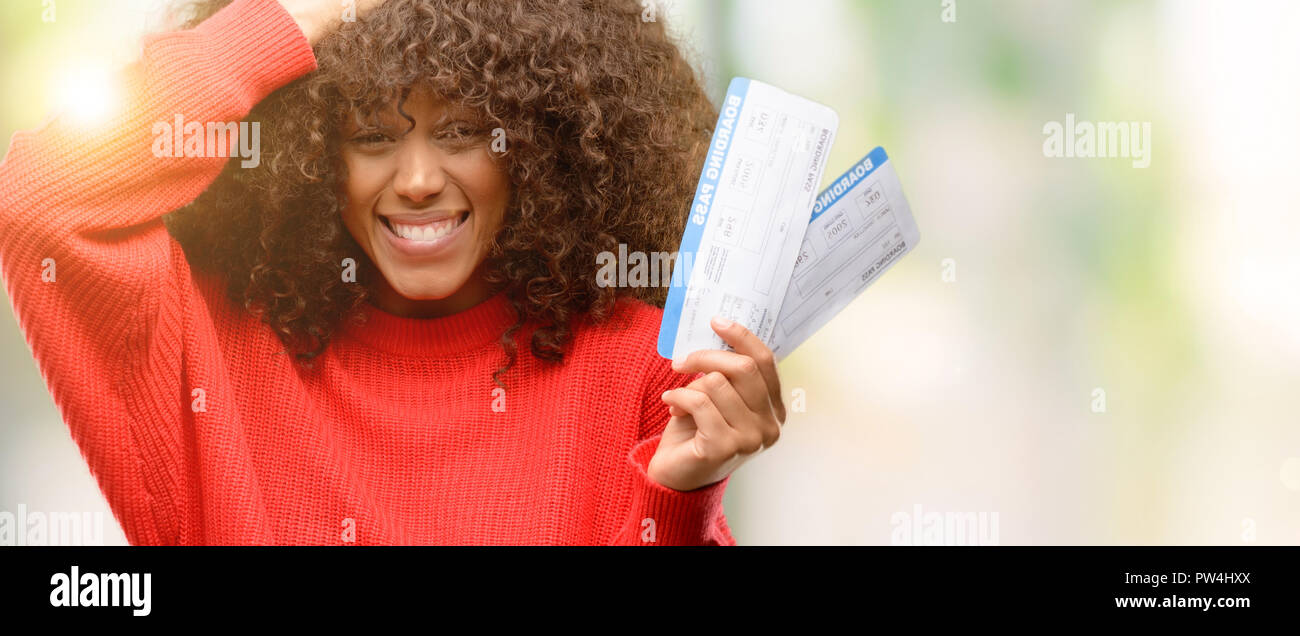African american woman holding airline boarding pass tickets stressed ...