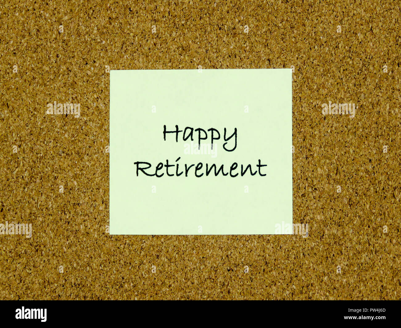 A yellow sticky note with happy retirement written on it on a cork ...