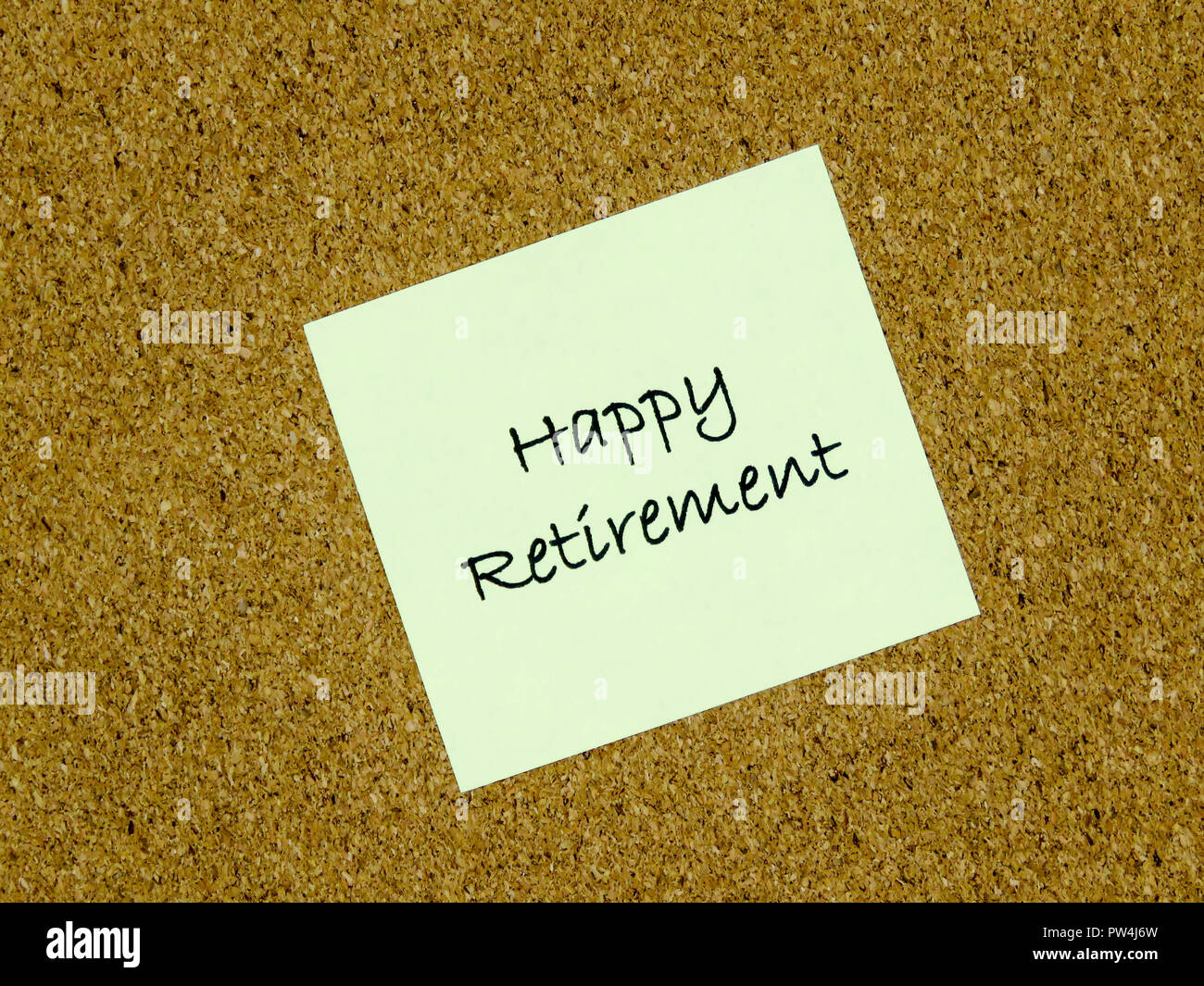 A yellow sticky note with happy retirement written on it on a cork ...