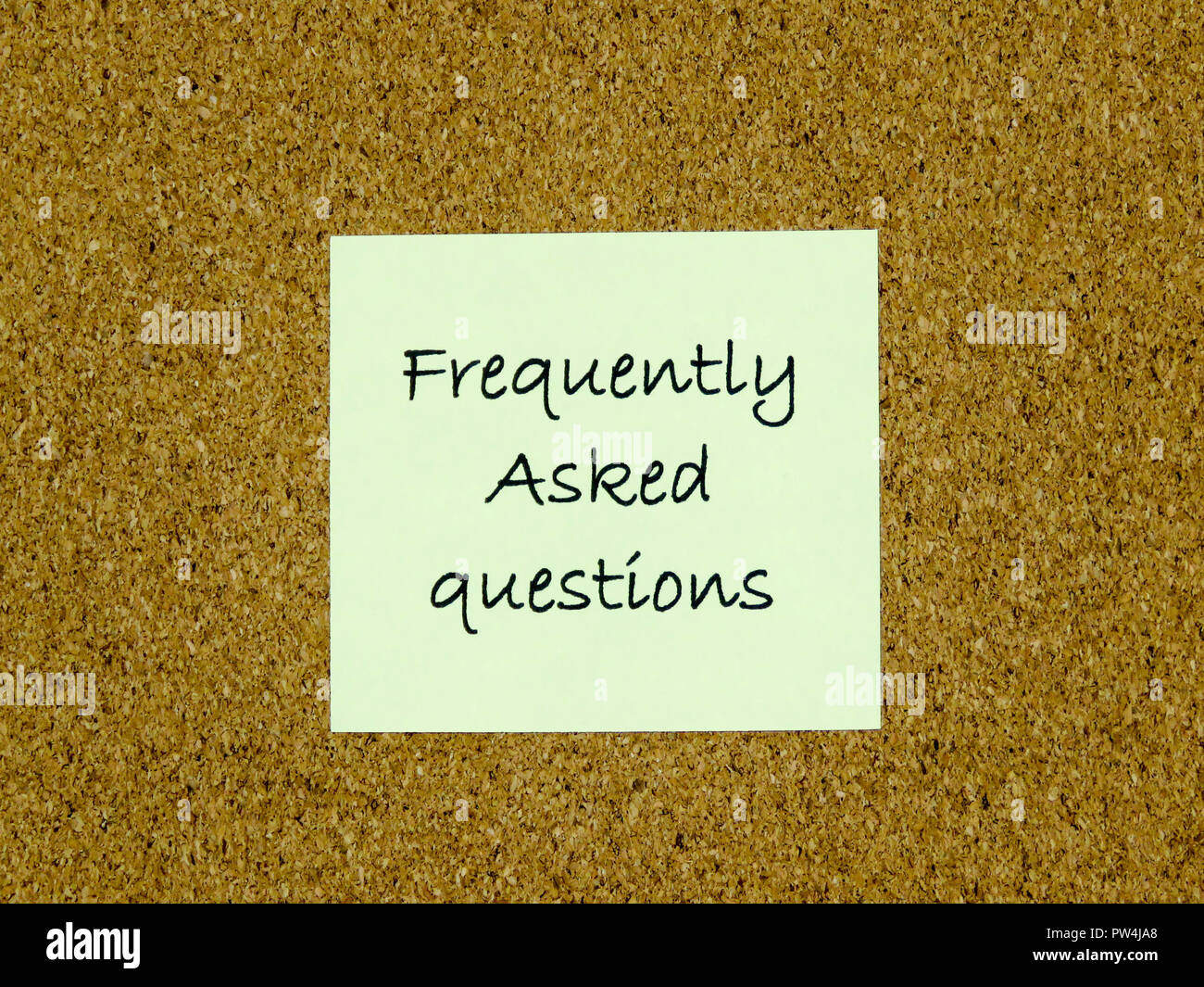 A yellow sticky note with frequently asked questions written on it on a ...