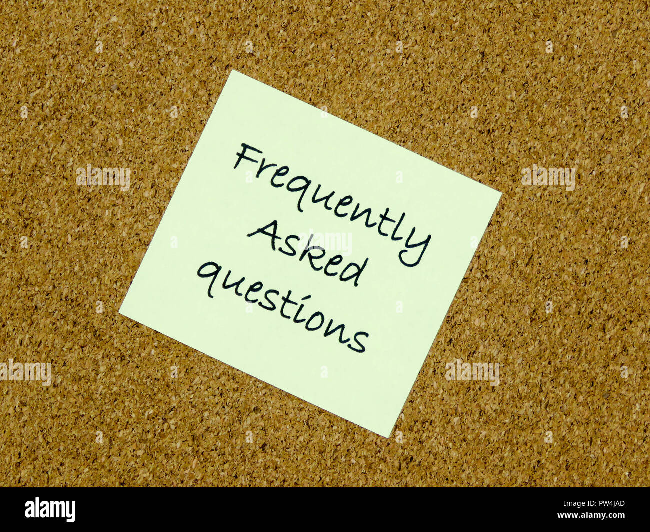 A yellow sticky note with frequently asked questions written on it on a ...