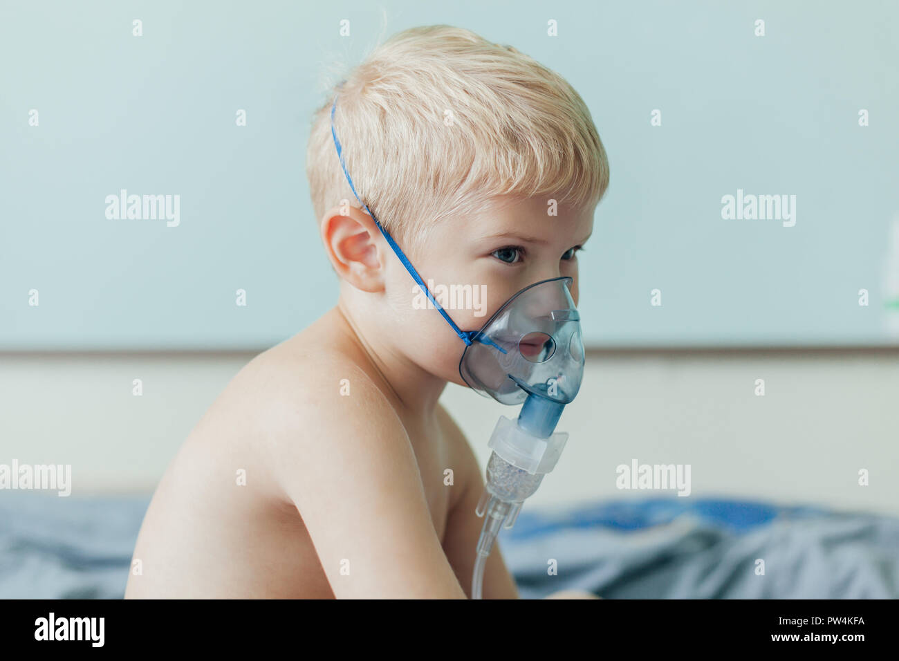Small boy does therapeutic inhalation using a nebulizer. Indoor Stock ...