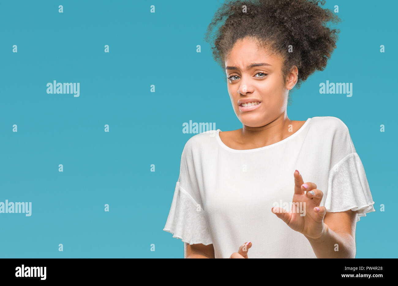 Young afro american woman over isolated background disgusted expression ...